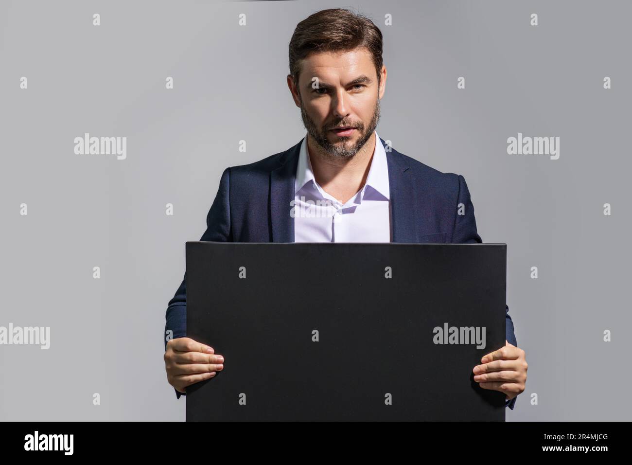Serious man holds the sign, blank card. Placard ready for your product ...
