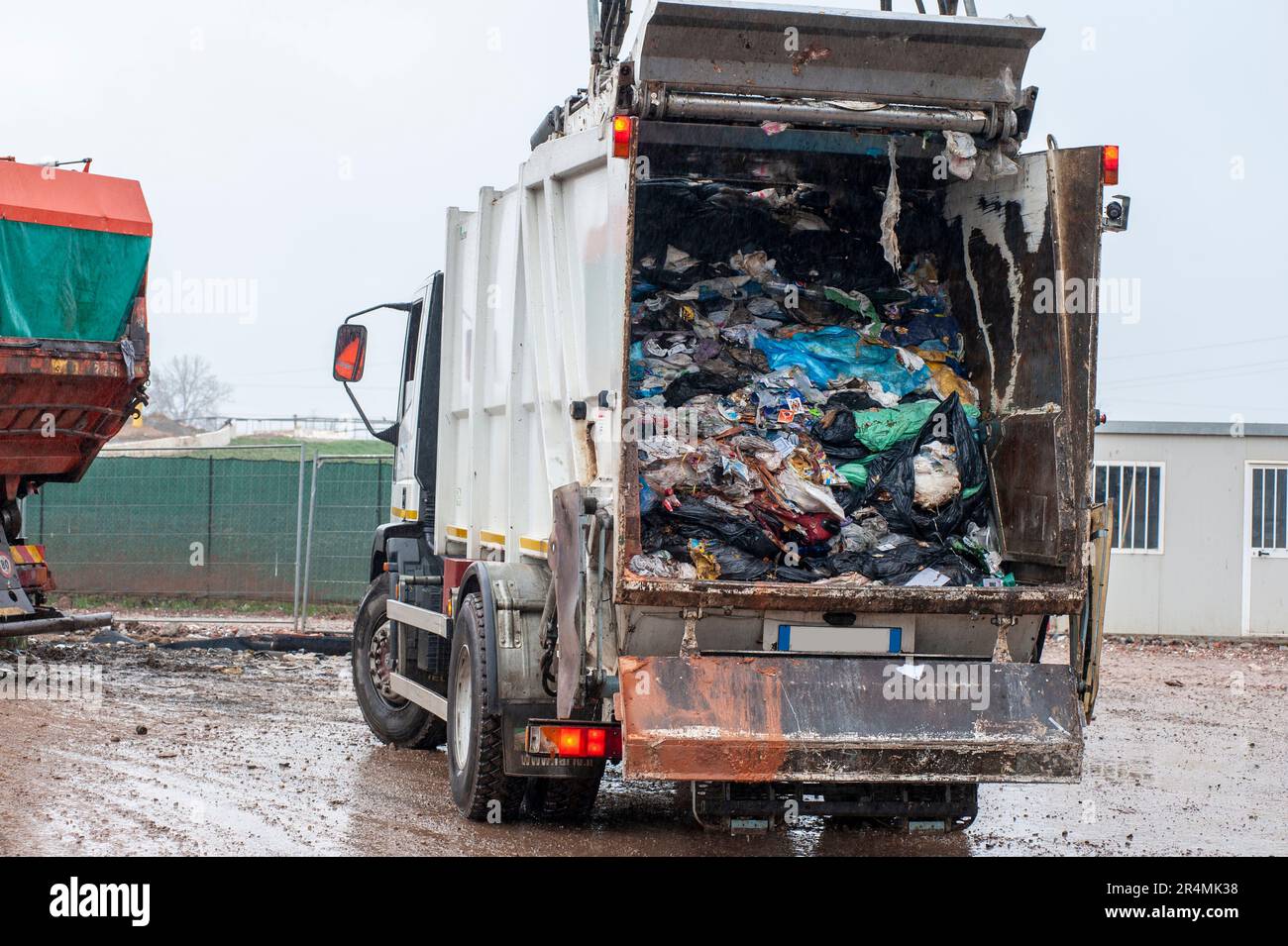 Dump municipal waste. Workers with trucks and bulldozers at work in ...