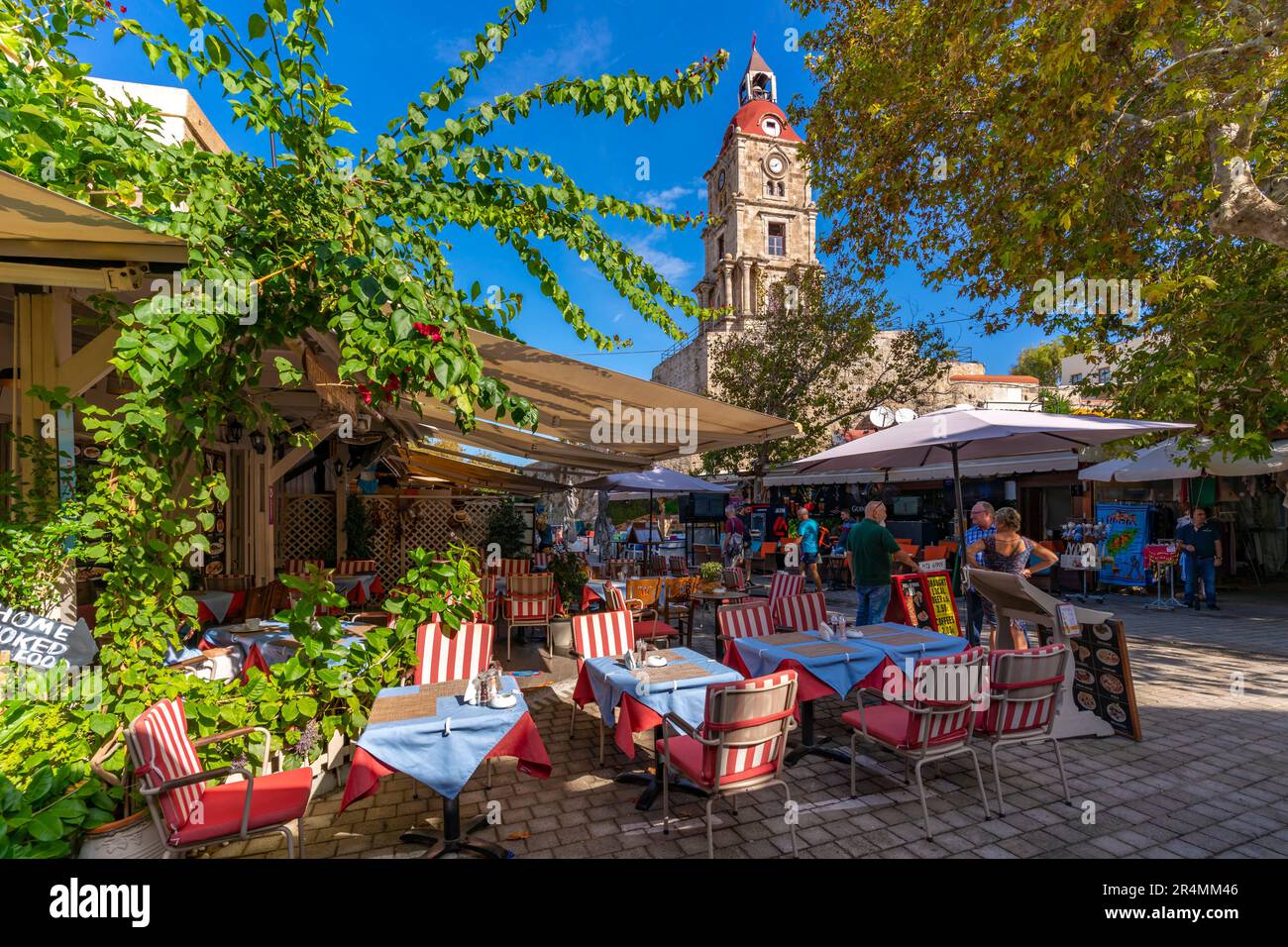 View of Medieval Clock Tower and cafe bars, Old Rhodes Town, UNESCO ...