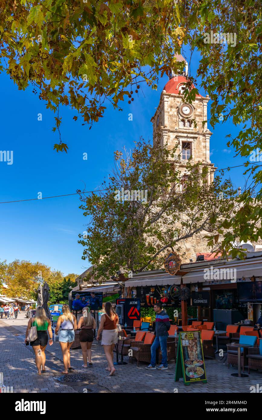 View of Medieval Clock Tower and cafe bars, Old Rhodes Town, UNESCO ...