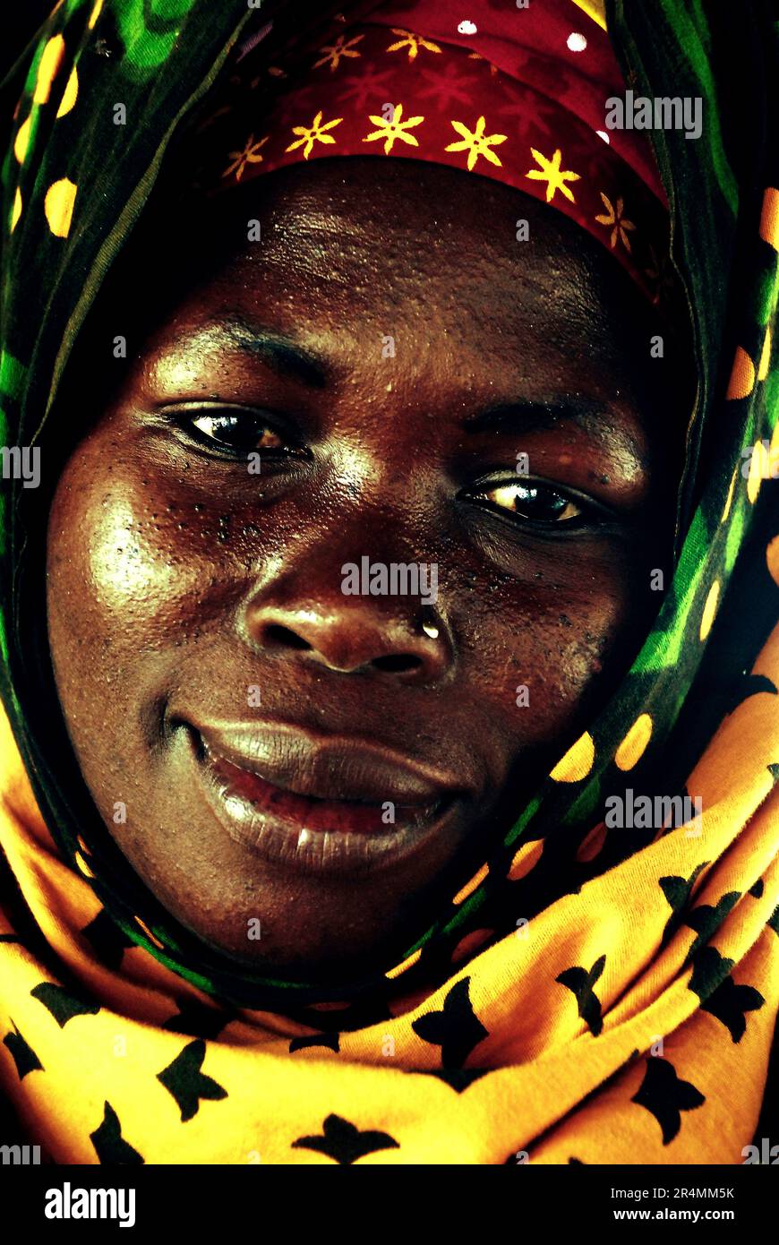 A portrait of an African woman wearing colorful fabric, in Mtwara ...