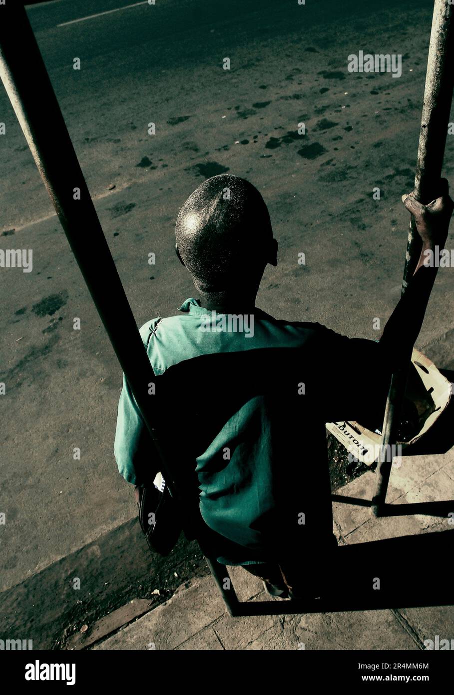 An old african man waits for the bus for a long time in Maputo ...