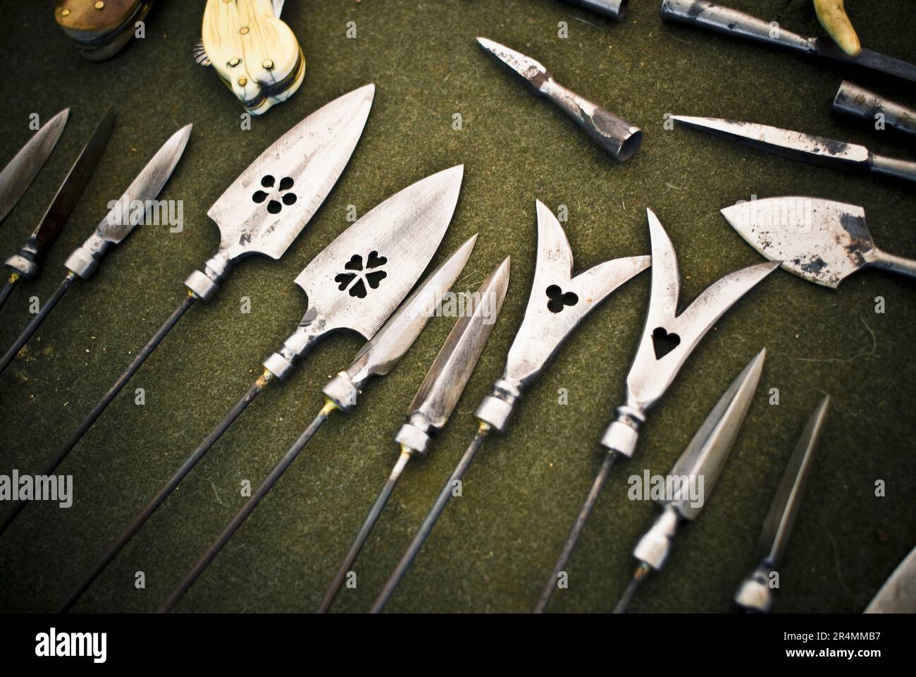 Detail of arrow heads hand forged by a blacksmith displayed on a table ...