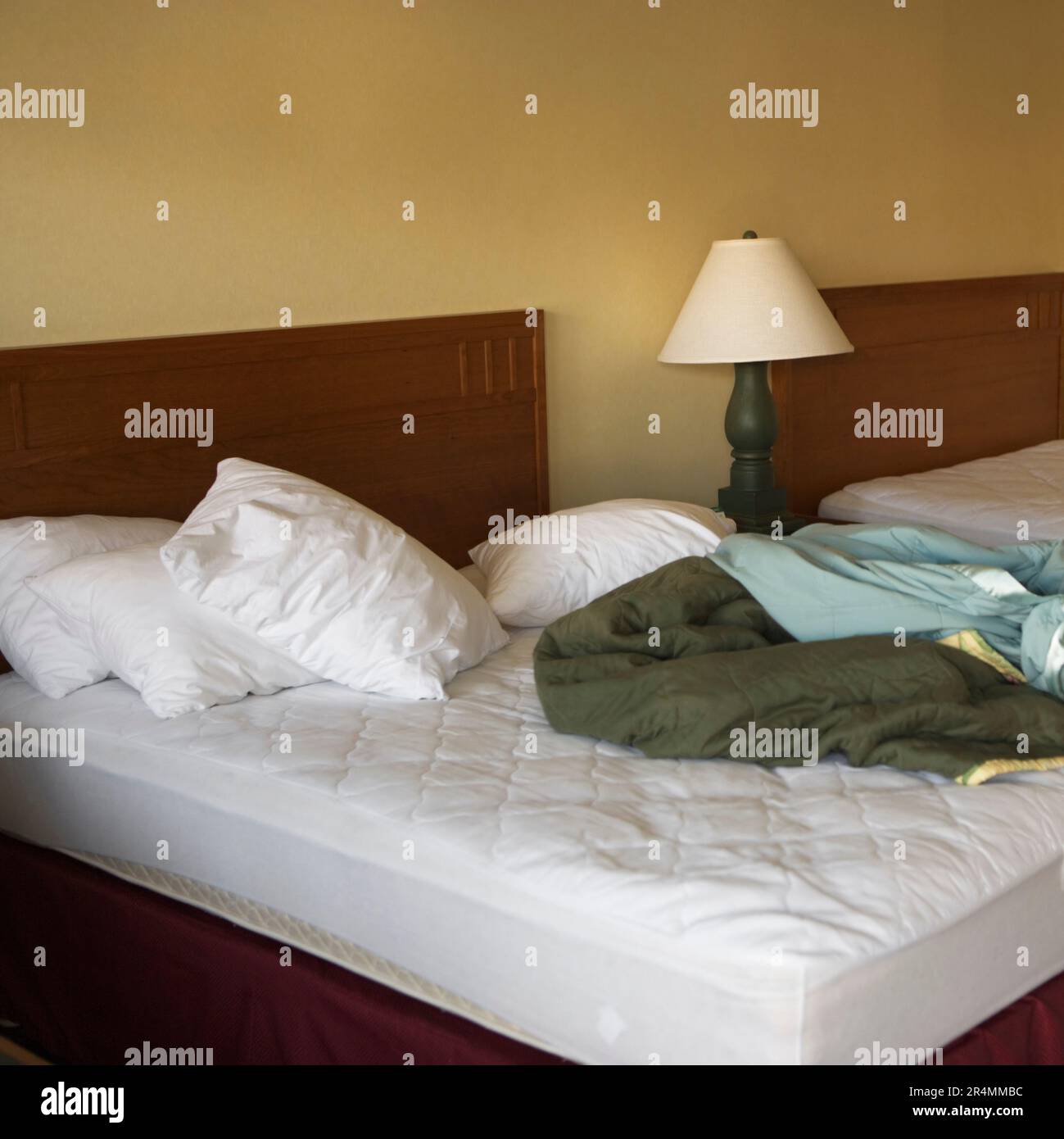 Empty unmade bed in a hotel room Stock Photo - Alamy