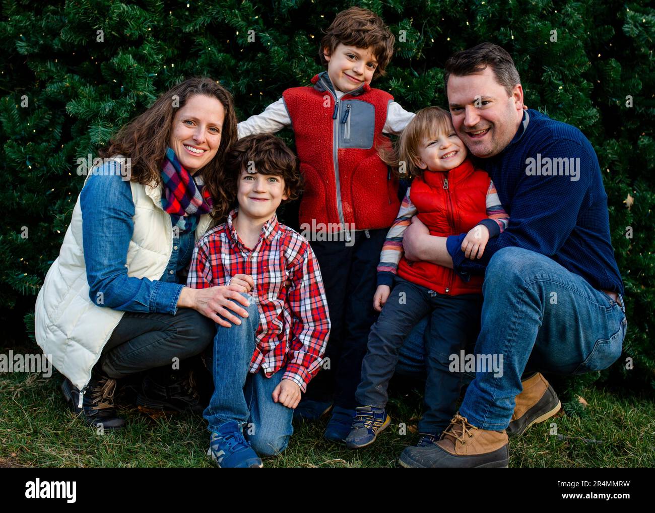 A happy family snuggle together for a family portrait outside Stock ...