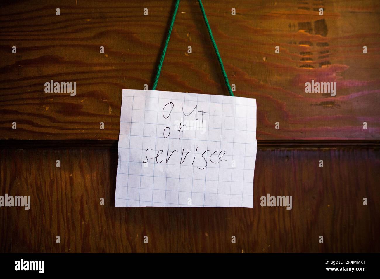 a small homemade sign in child's handwriting reads, "out of service ...