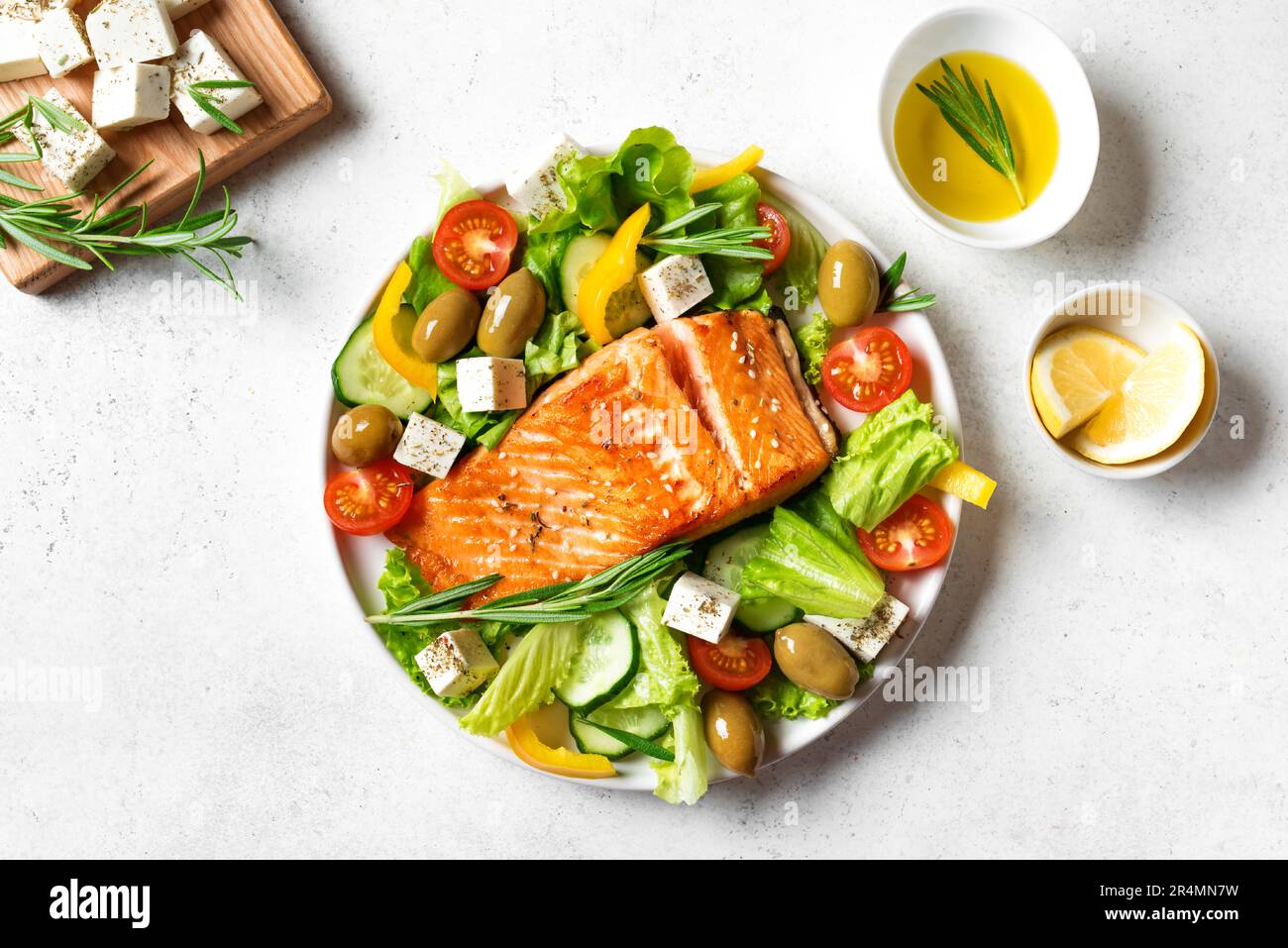 Grilled salmon fish fillet and fresh vegetable salad with tomato ...