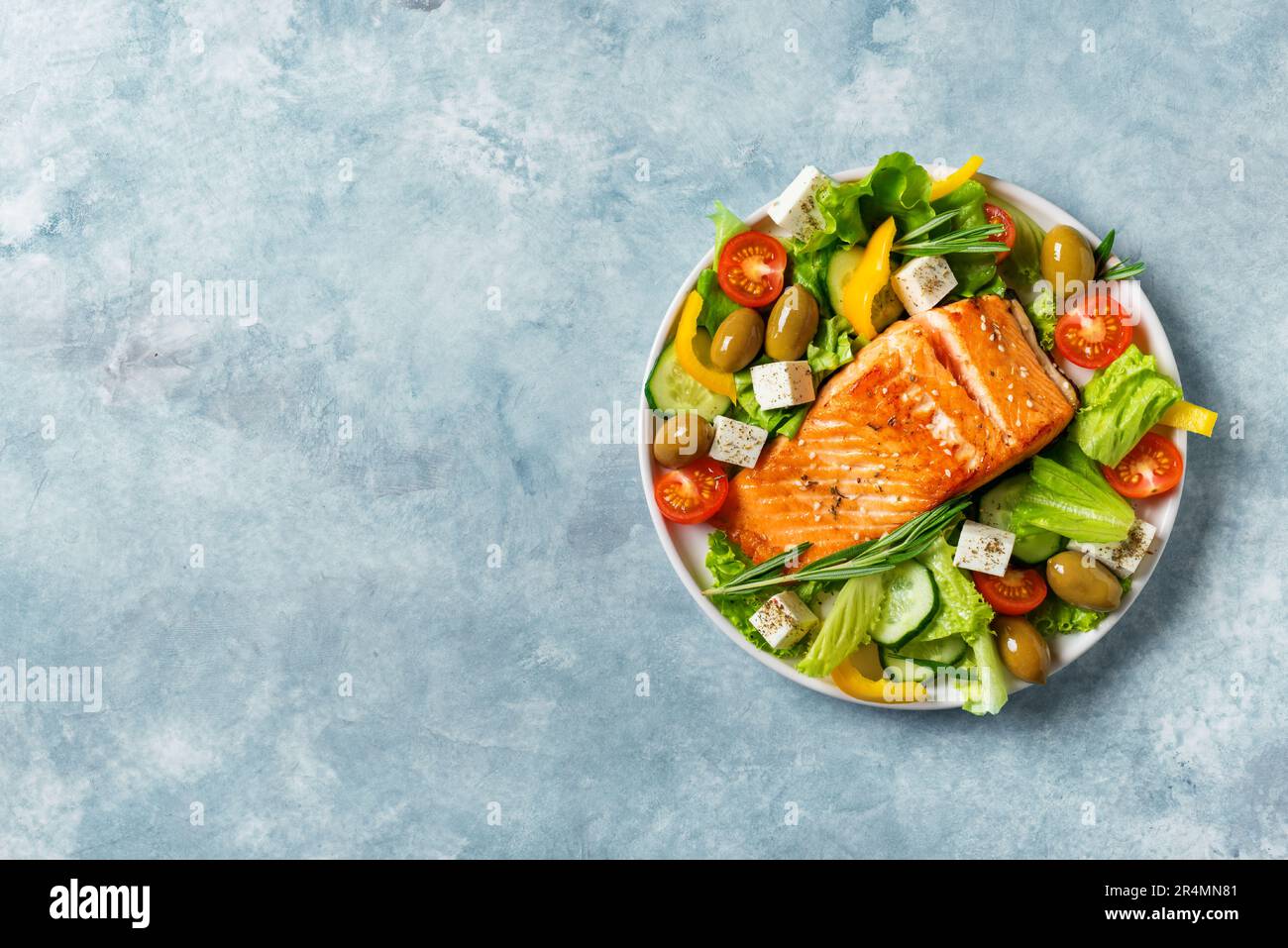 Grilled salmon fish fillet and fresh vegetable salad with tomato ...