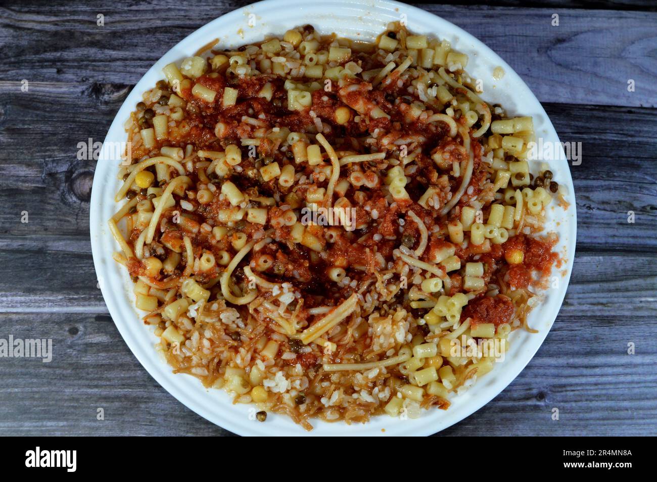 Egyptian cuisine of Koshary, a popular street food made of rice ...