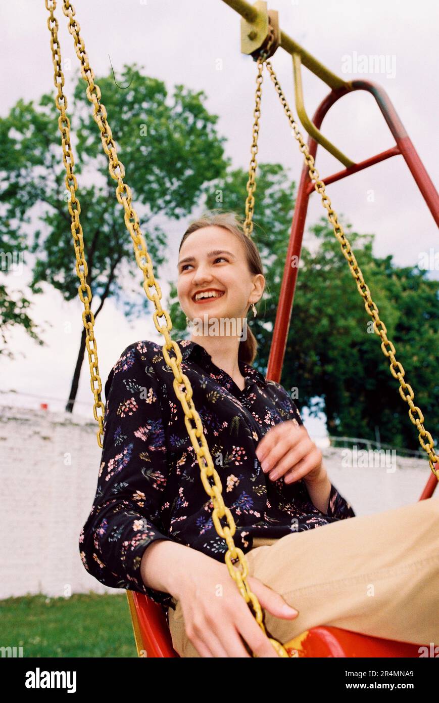happy woman smiling and riding a swing Stock Photo - Alamy