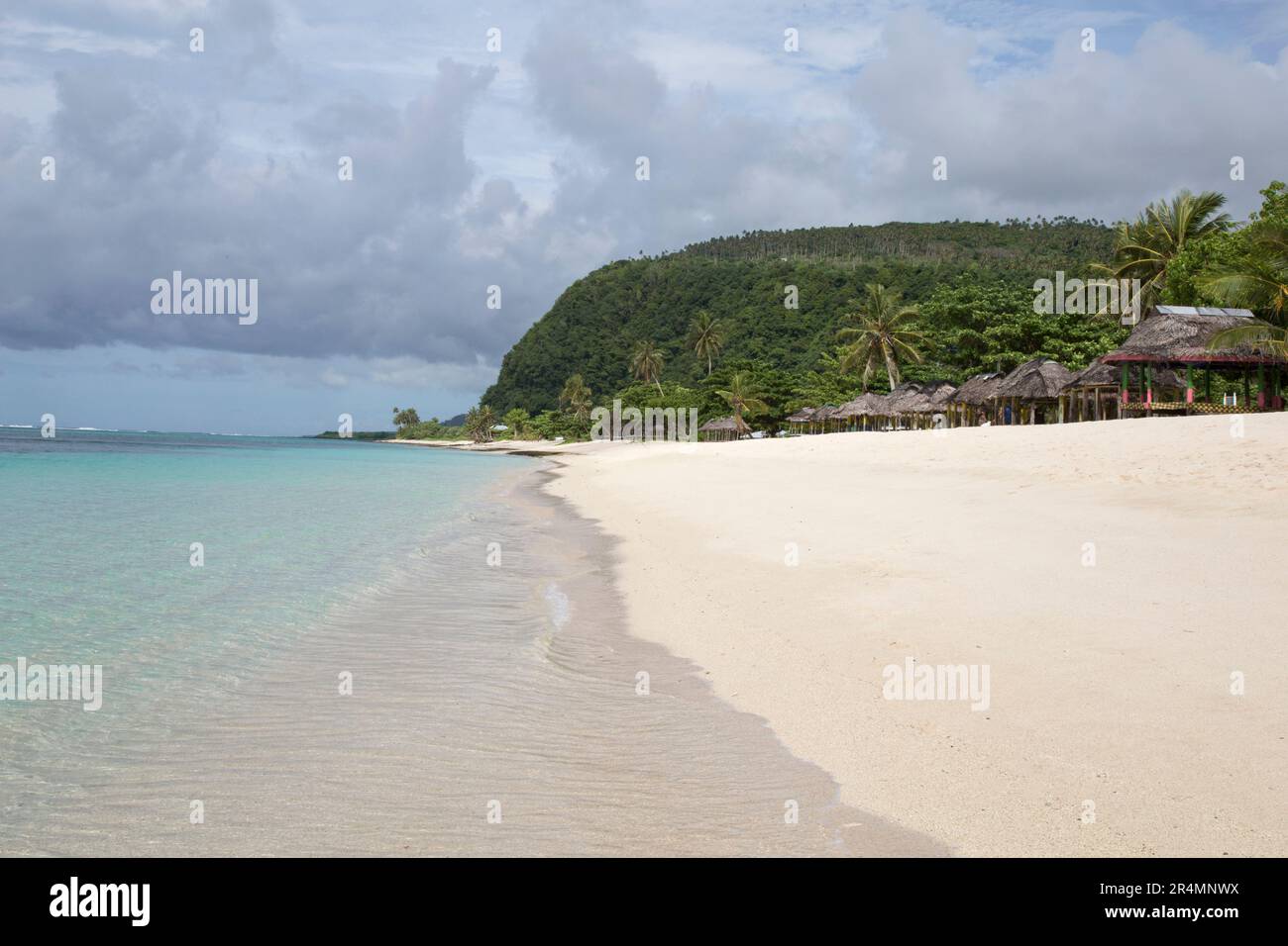 Sandy white beach with palmtrees and huts Stock Photo - Alamy