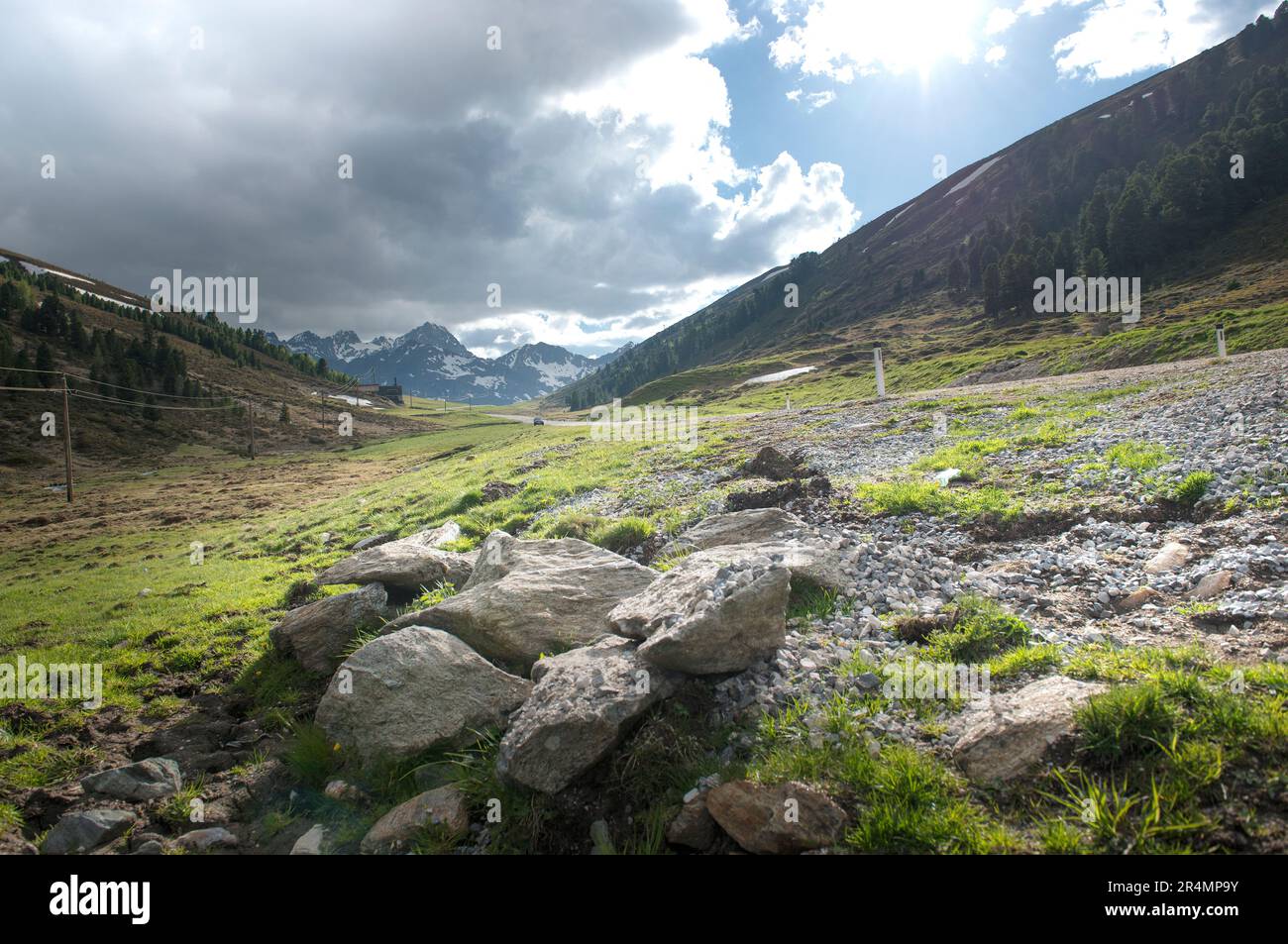 Pile of rocks at roadside in rugged alpine landscape Stock Photo - Alamy