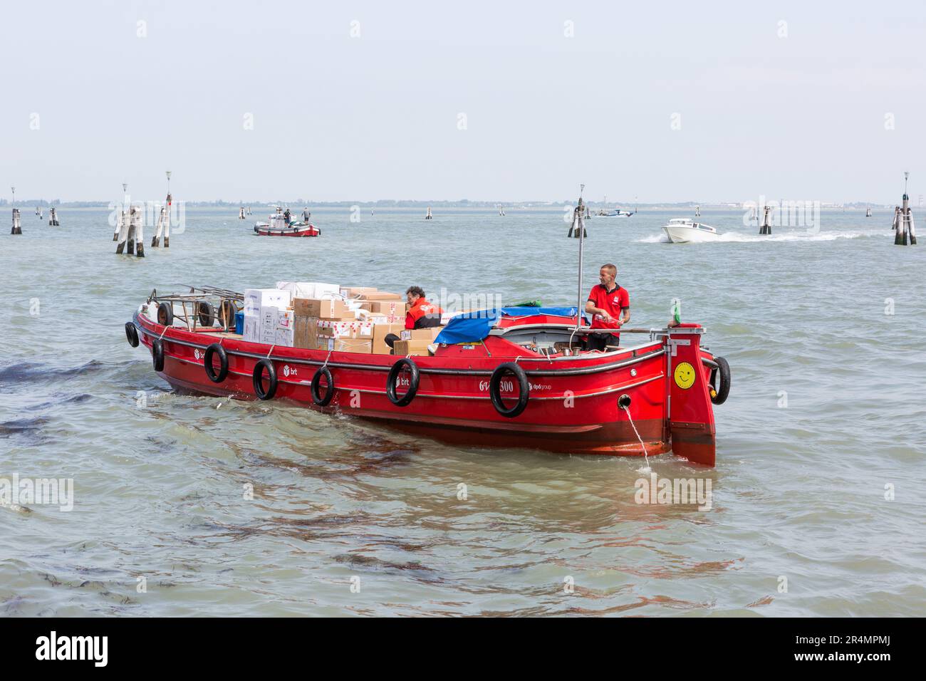 A boat delivery boat loaded with parcels and goods in Venice, Italy ...