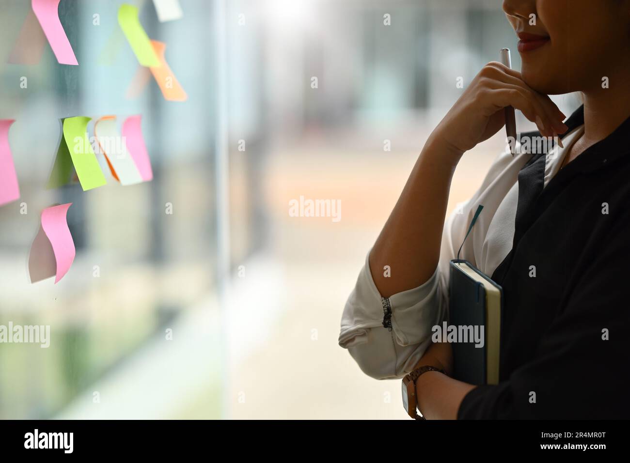 Thoughtful female employee writing tasks, new ideas planning corporate ...