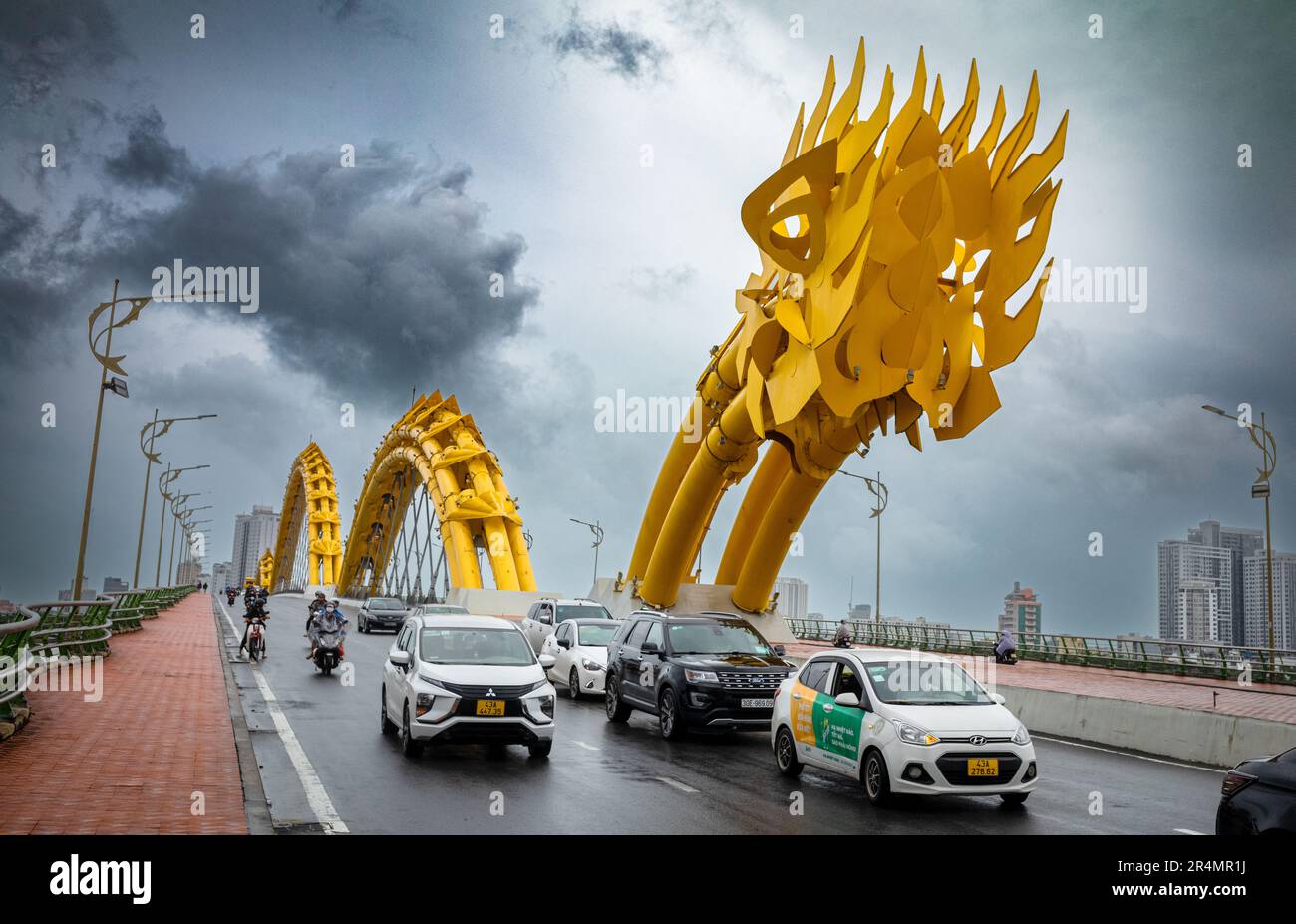 Traffic crosses The Dragon Bridge in the rain in Danang, Vietnam. The ...