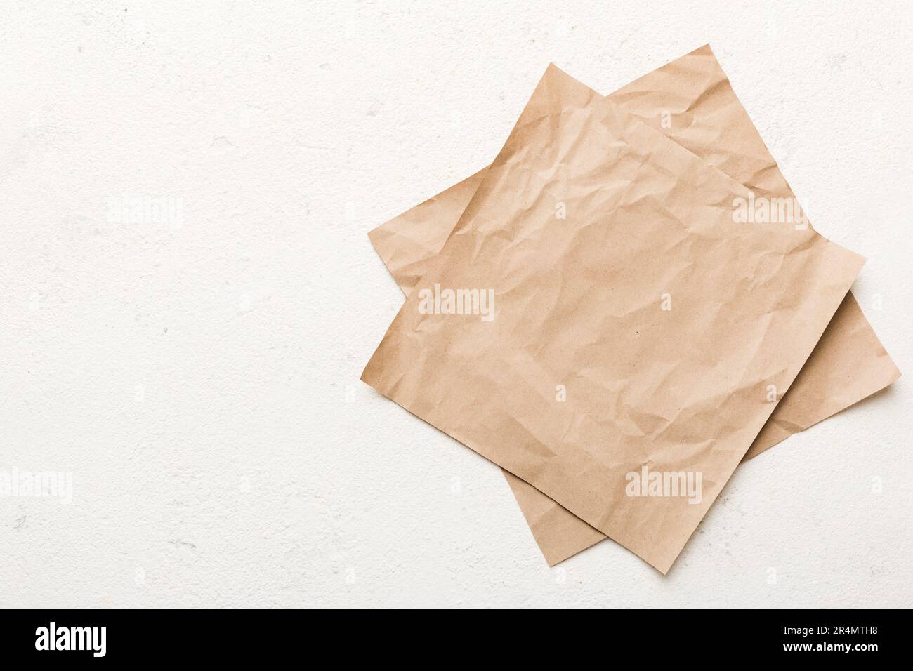 top view with baking parchment empty on table background. Folded cloth ...