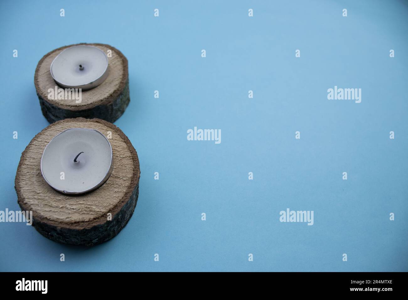 Small logs placed on the edge of the blue background, photographed from ...