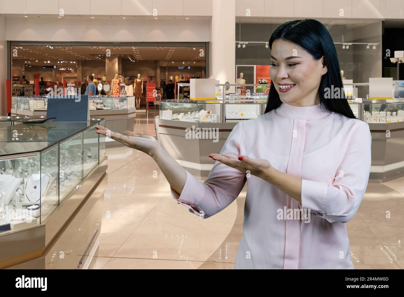 Happy smiling asian woman showing advertising copy space with both ...