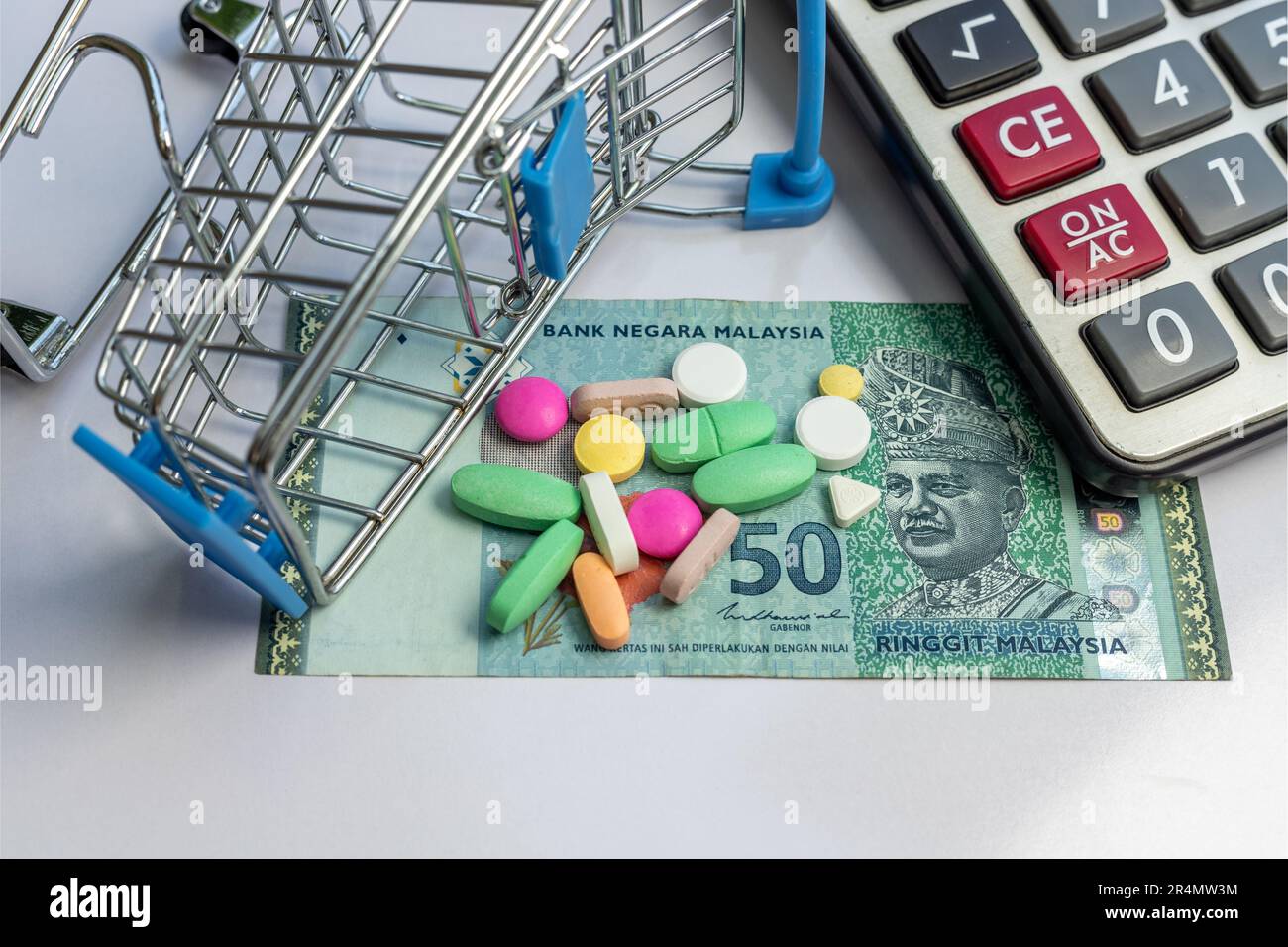 Malaysian ringgit and medicine on white isolated background. Cost of ...