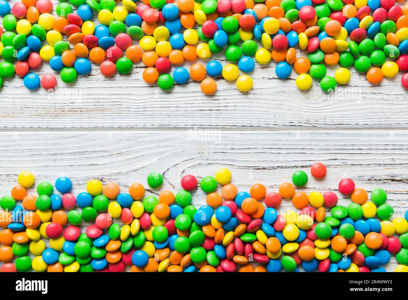 Mixed collection of colorful candy, on colored background. Flat lay ...