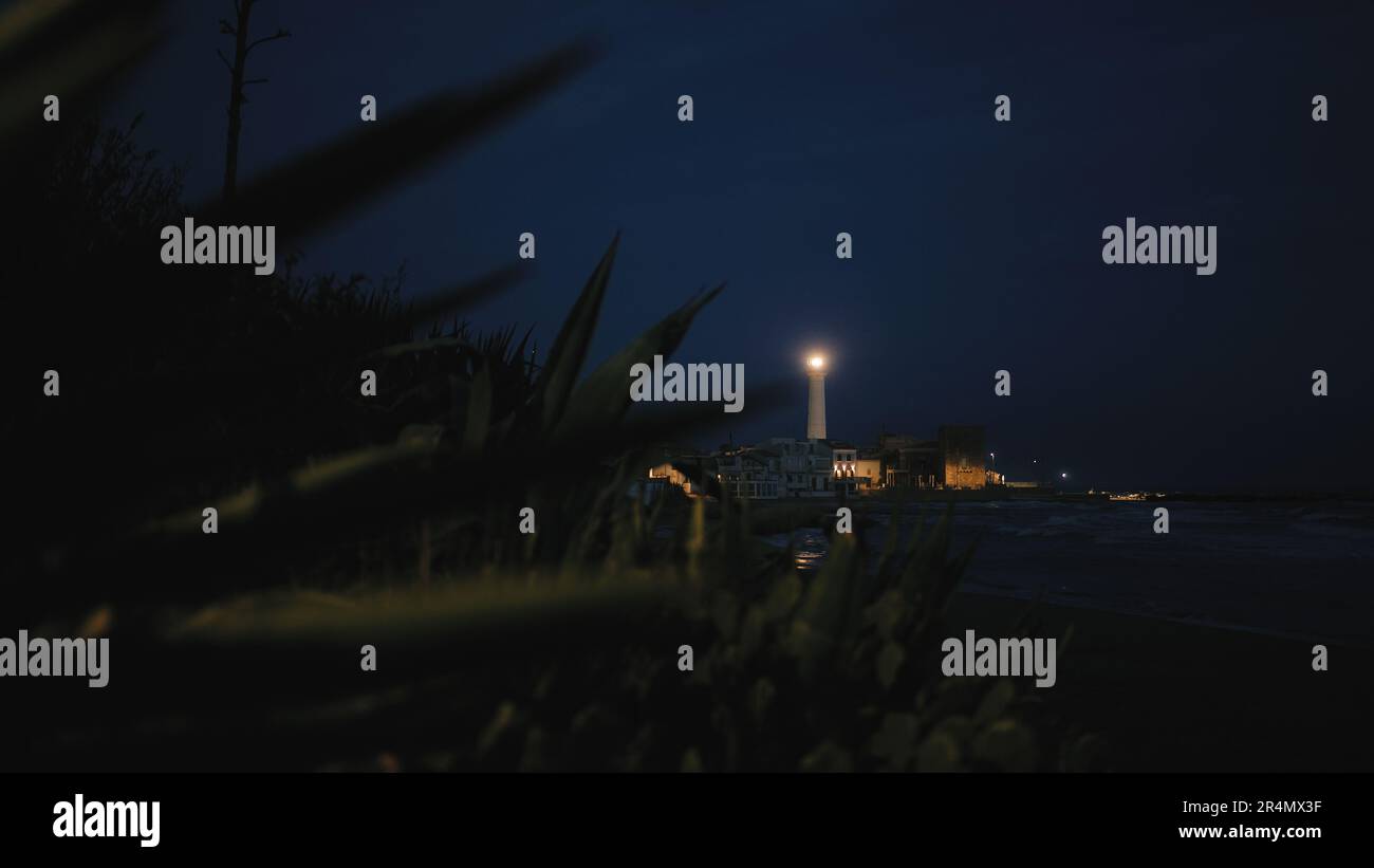 Lighthouse tower flashes at night Stock Photo - Alamy