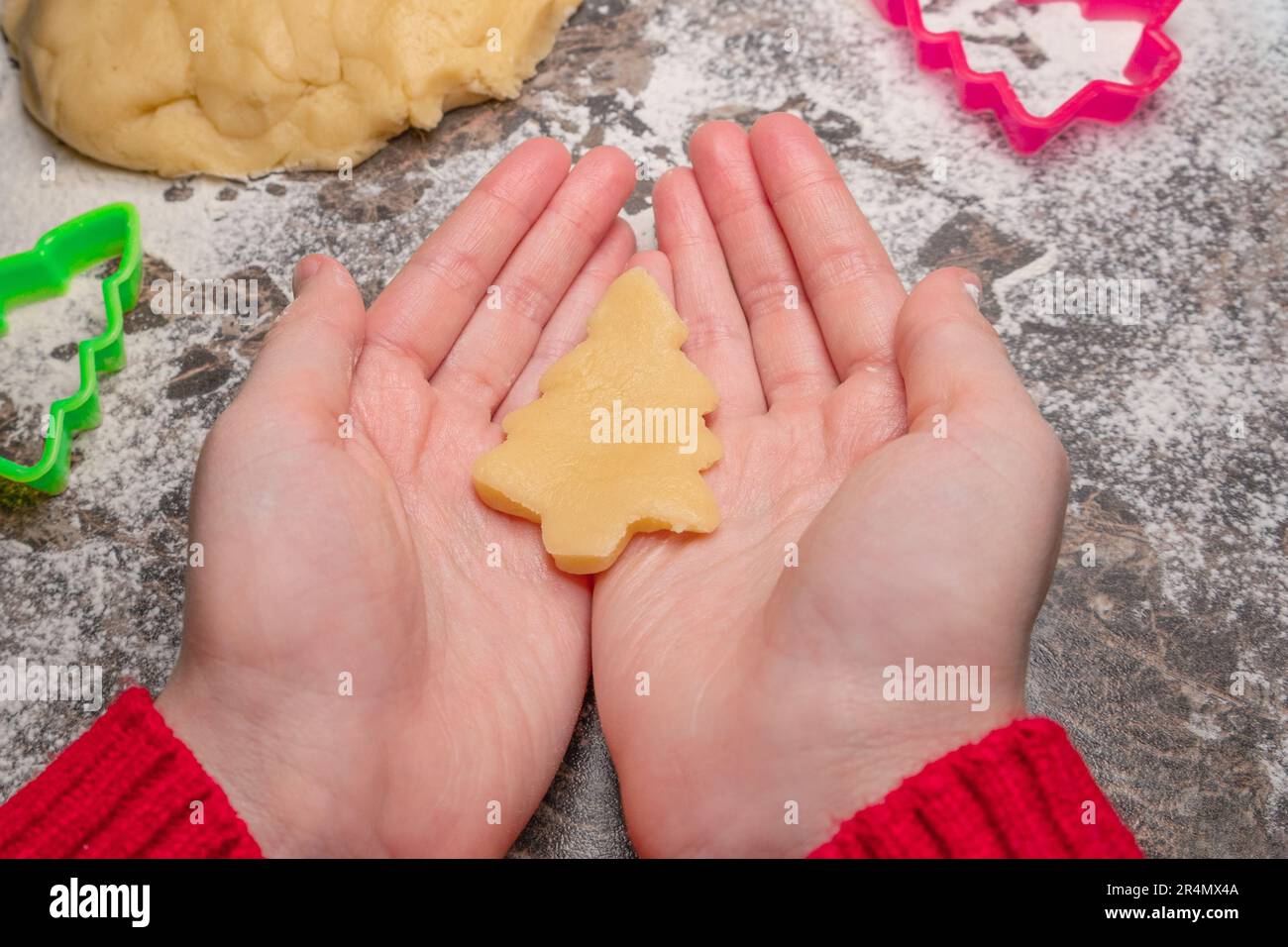 Kids hand with form of christmas cookies for children, making ...