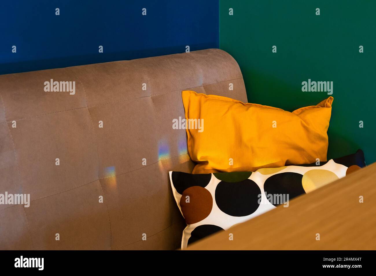 Cafe interior with blue and dark green walls and orange pillows ...