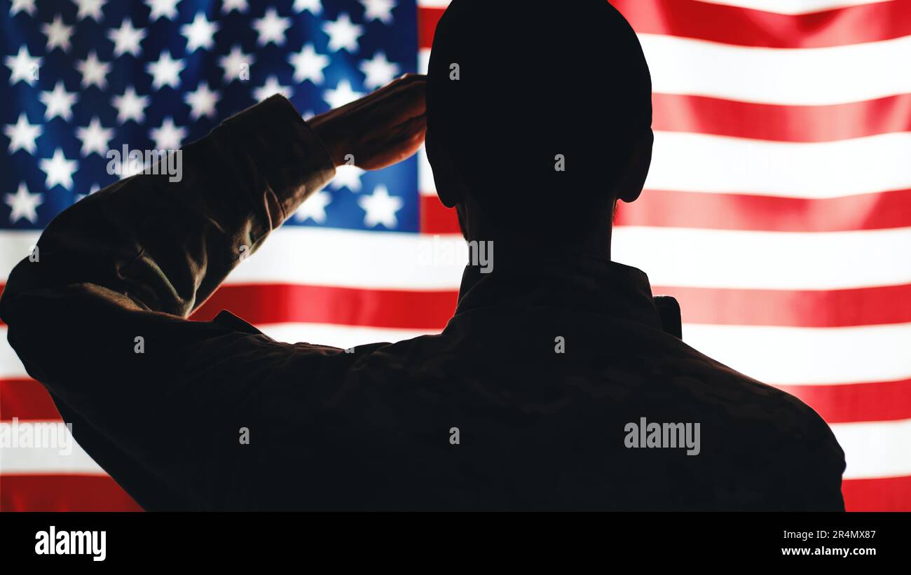 American soldier salutes in front of the American flag Stock Photo - Alamy