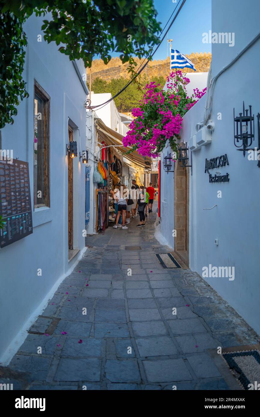 View of Lindos Acropolis from a Lindos street at sunset, Lindos, Rhodes ...