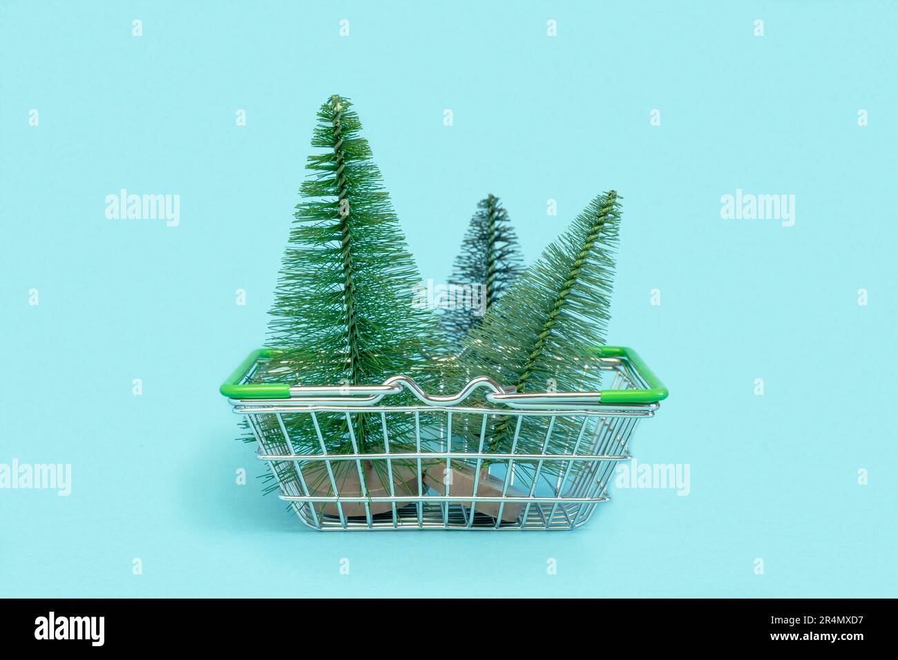 Small Christmas tree is in a shopping cart. Artificial mini Christmas ...