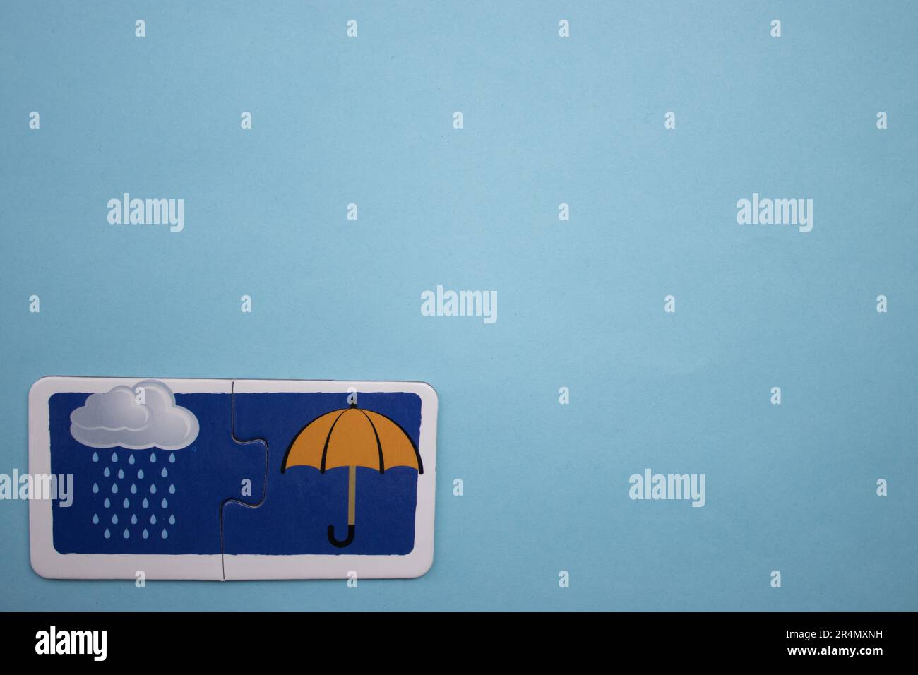 Picture puzzles placed on the edge of a blue background. Rain cloud and ...