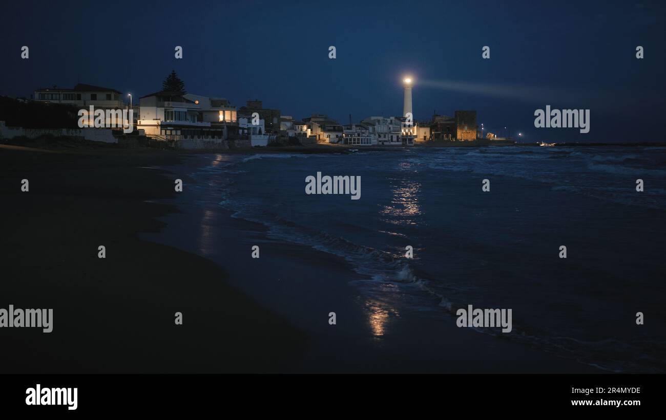 Lighthouse tower flashes at night Stock Photo - Alamy