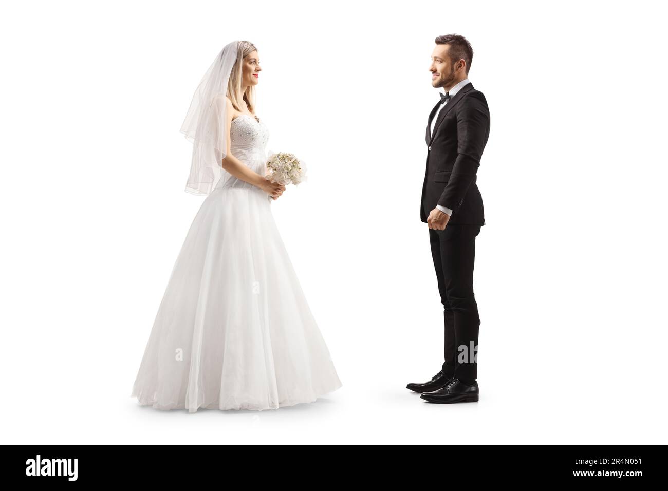 Full length profile shot of a bride looking at a groom isolated on ...