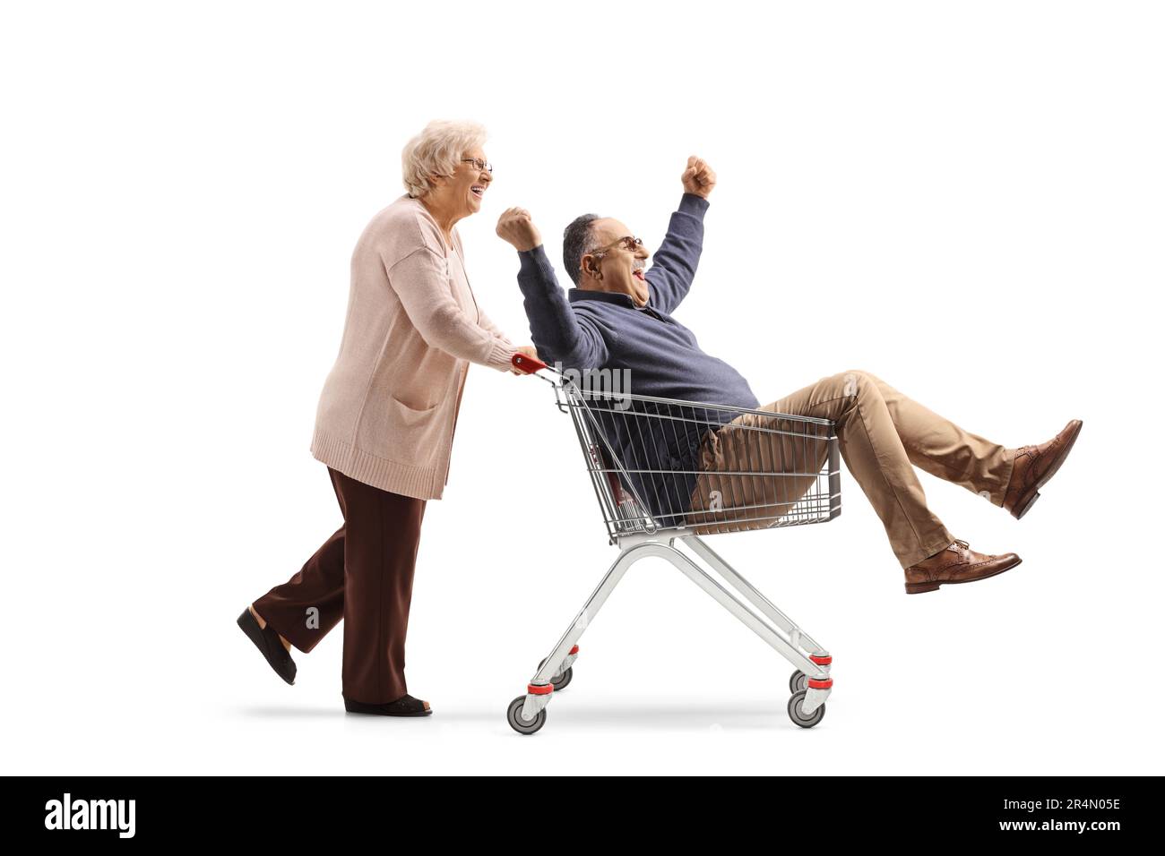 Elderly woman pushing a shopping cart with a man inside isolated on ...