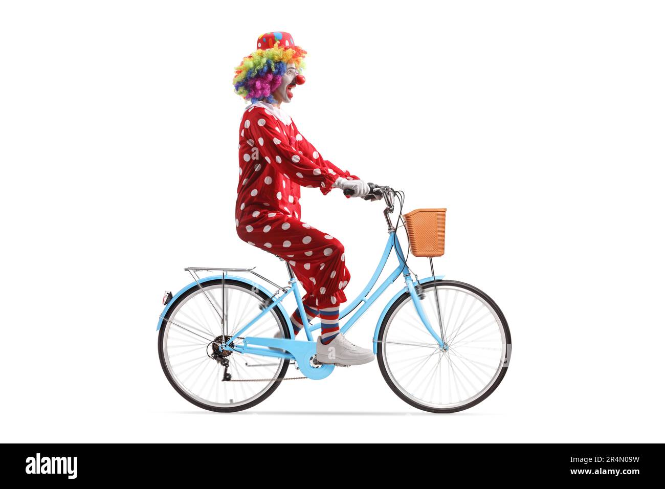 Full length profile shot of a clown riding a bicycle isolated on white background Stock Photo ...
