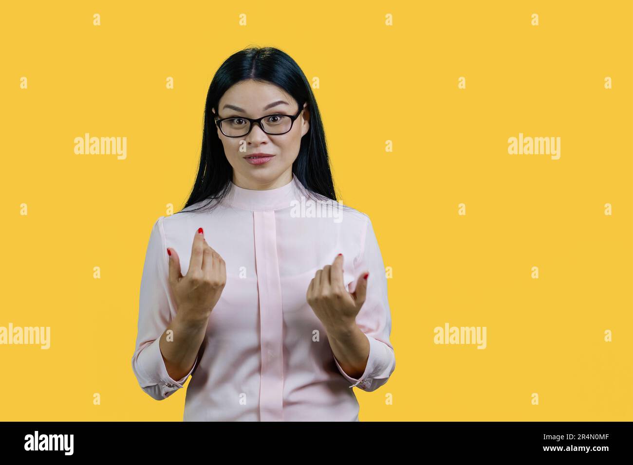 Portrait of a young asian woman is explaining herself. Isolated over ...