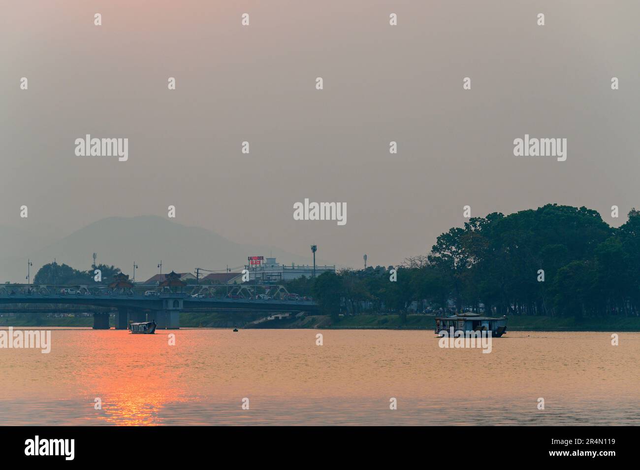 The sun setting over Perfume River on a balmy evening in Hue, Vietnam ...
