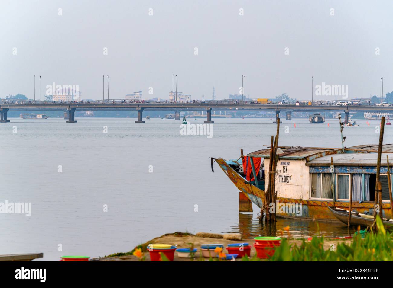 Phu Xuan Bridge with heavy traffic crossing Perfume River with boats ...