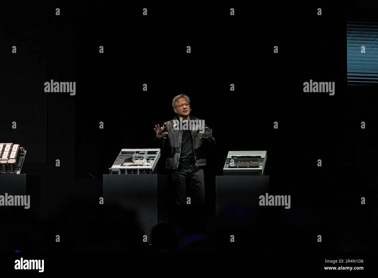 Nvidia president and CEO Jensen Huang speaks at a keynote while holding ...