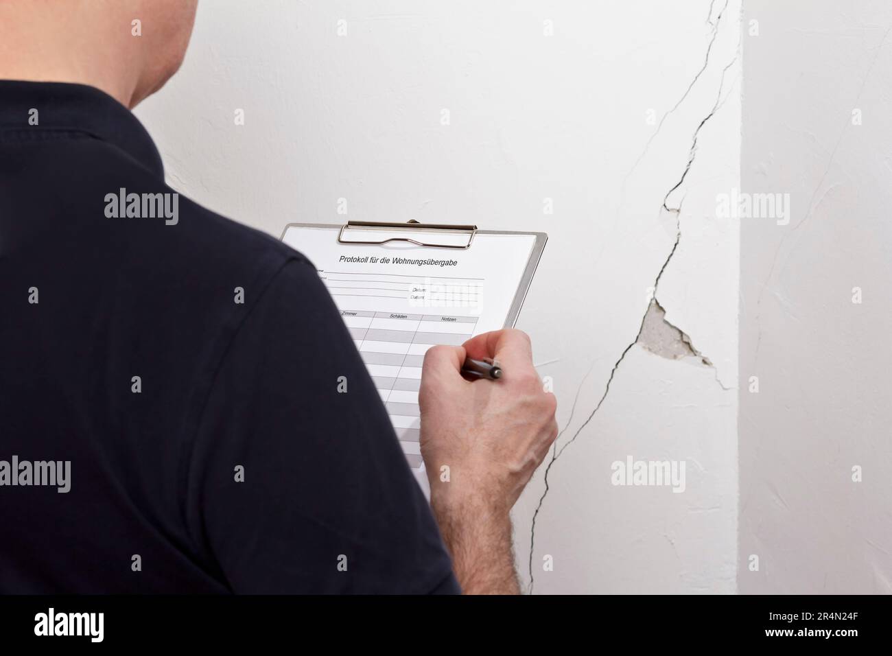 Rental damage concept: man with german inspection checklist in front of ...