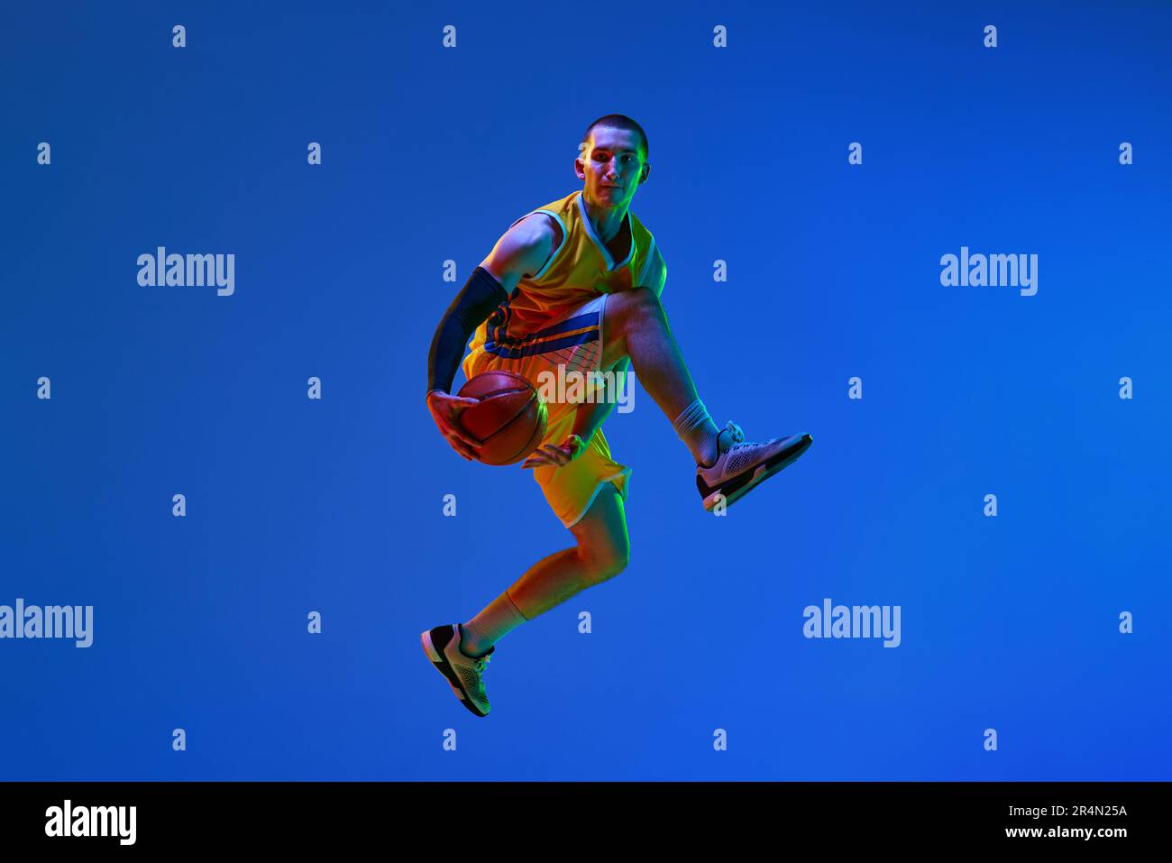 Dynamic image of professional male basketball player in motion, jumping ...