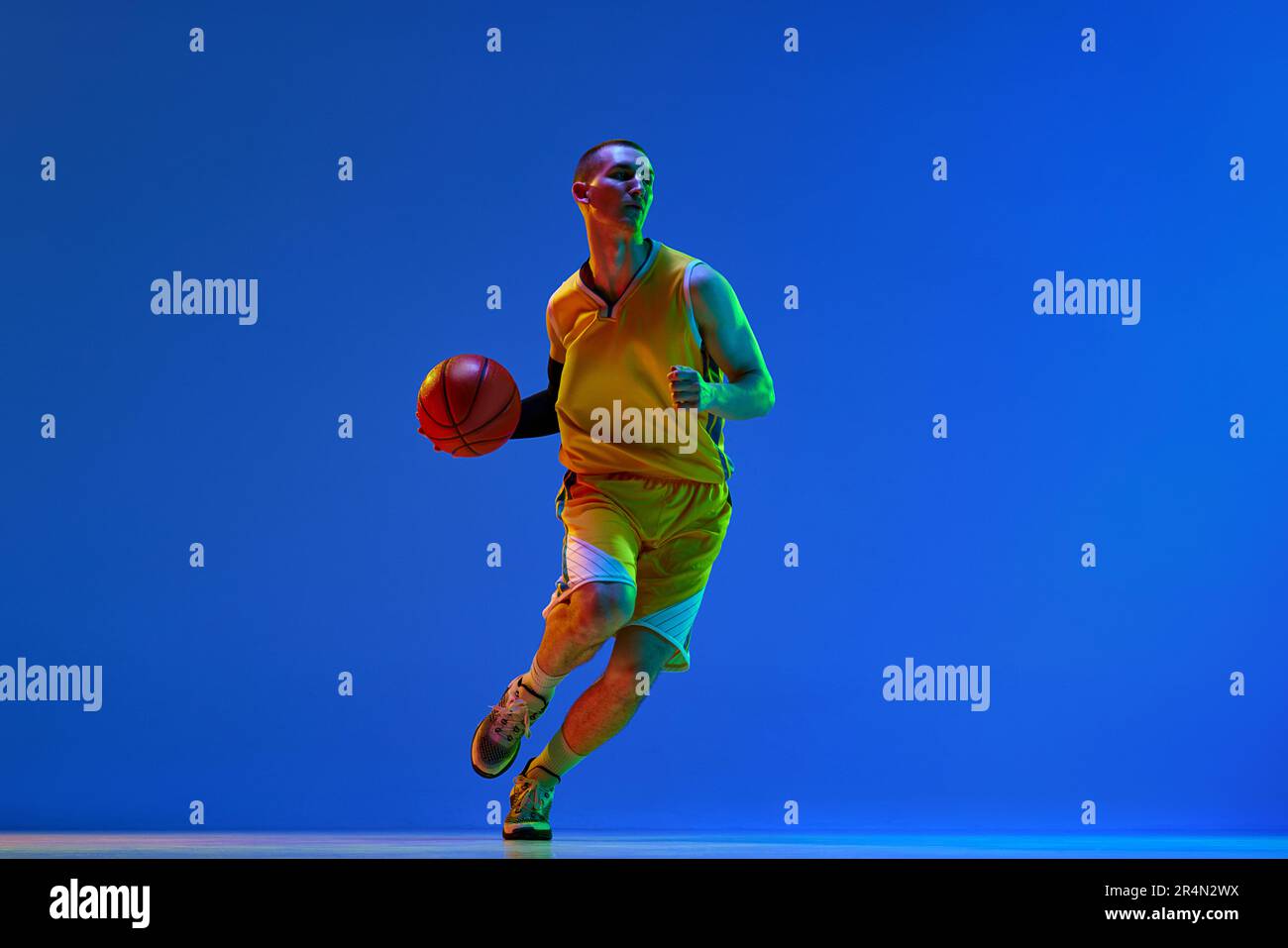 Dynamic image of young man, basketball player in motion during game ...