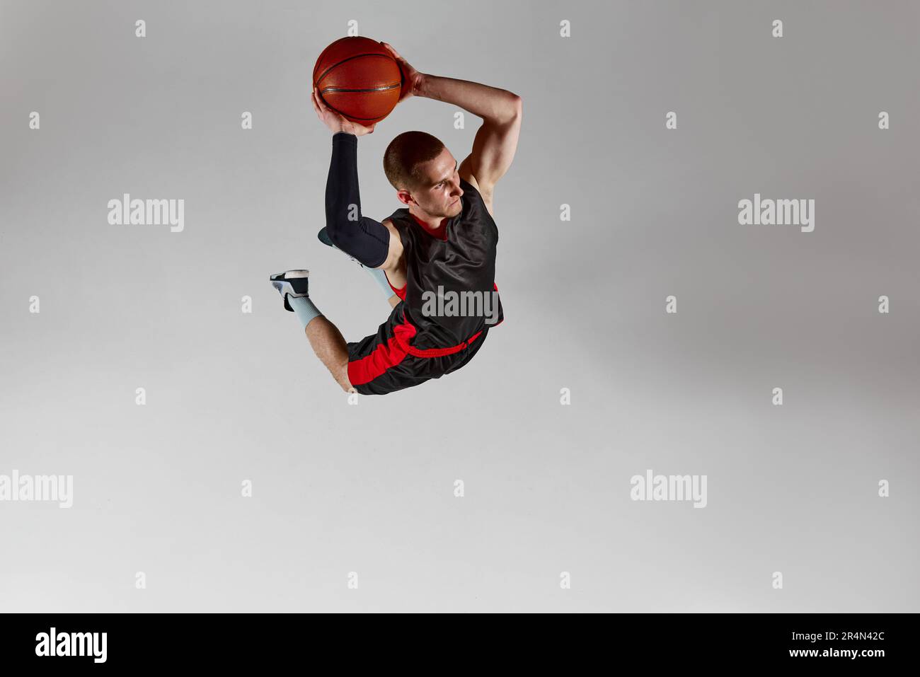 Dynamic image of concentrated young man, basketball player throwing all ...