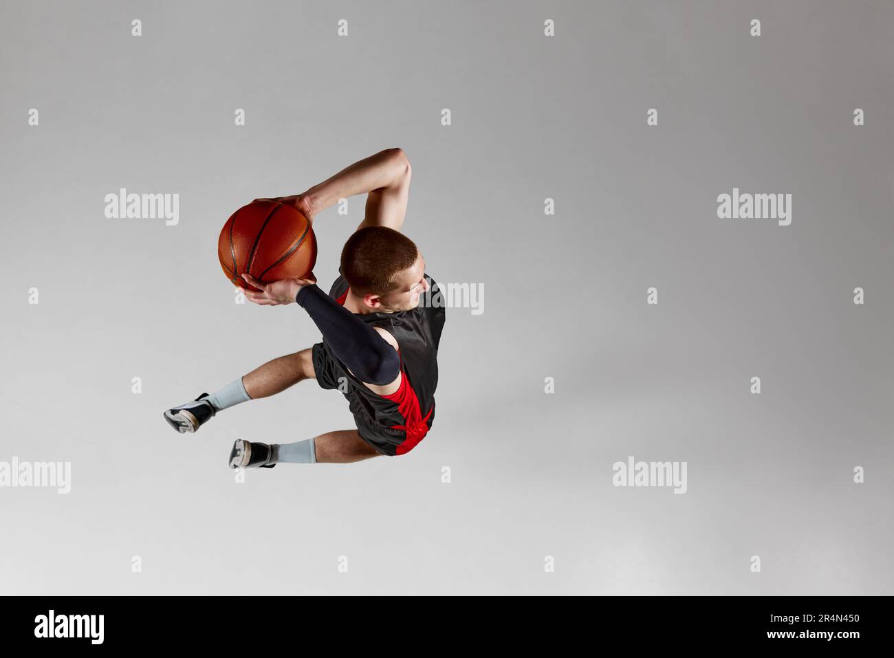 Motivated, concentrated young man, basketball player throwing all in a ...