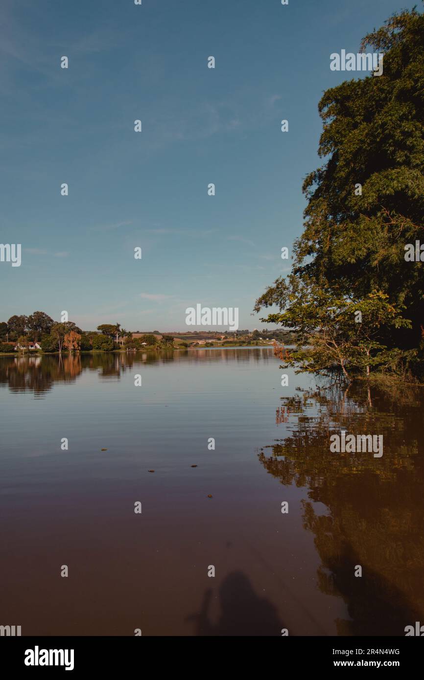 shadow of fishermen on calm river Stock Photo - Alamy