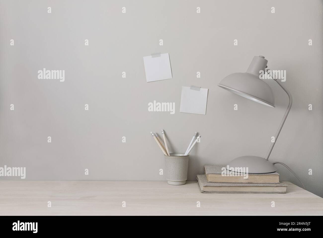Wooden desk with lamp, books and cup holder for pencils. Note pad ...