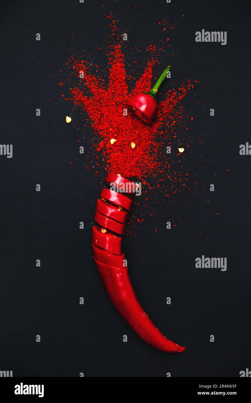 Exploding pepper. Chili pepper turns into powder. Dark background Stock ...