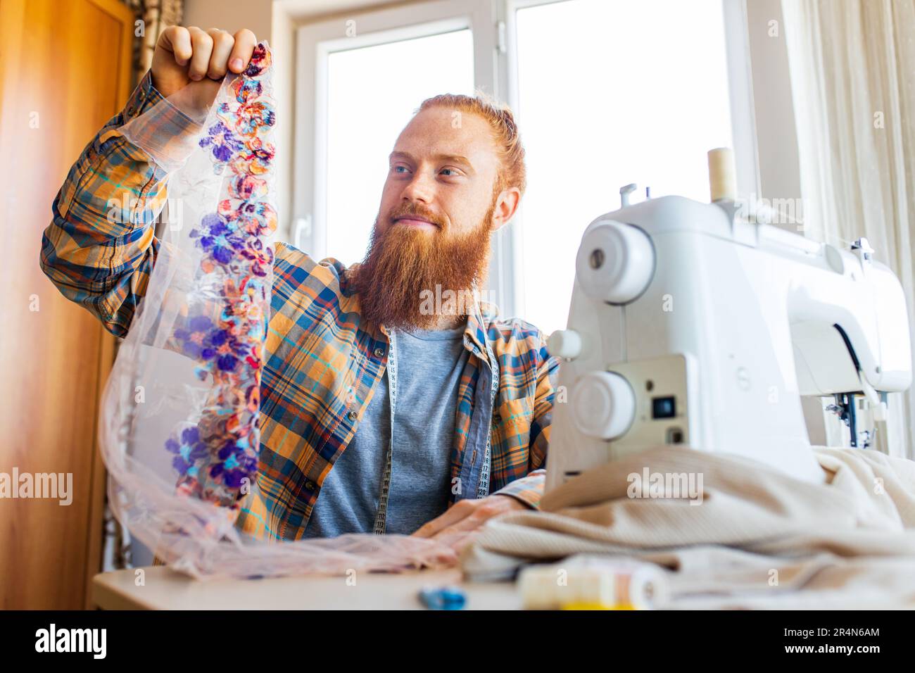 Man sews sewing machine designer hi-res stock photography and images ...