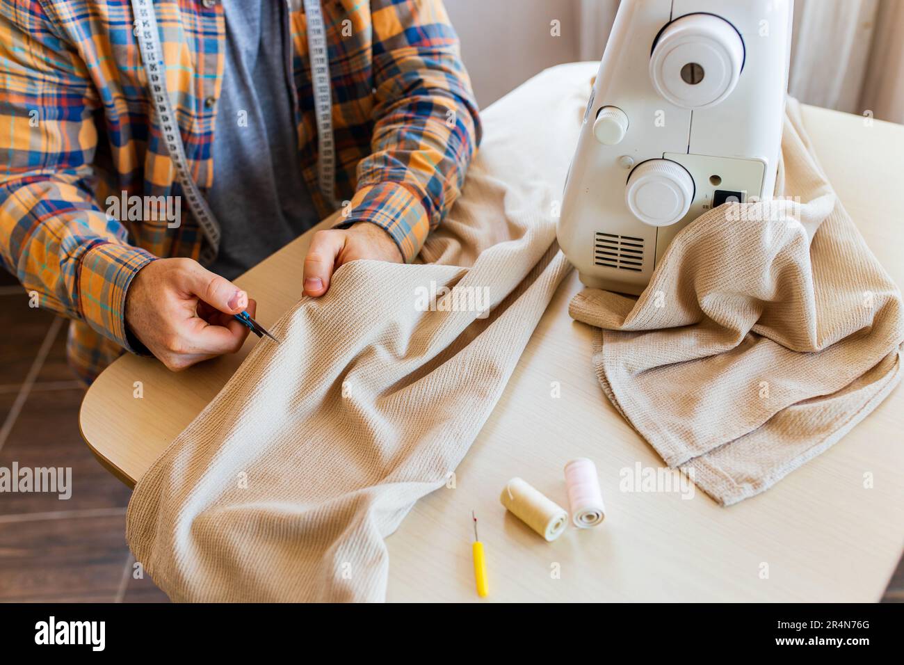Man sews sewing machine designer hi-res stock photography and images ...