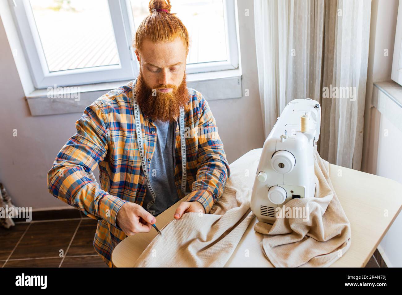 Man sews sewing machine designer hi-res stock photography and images ...